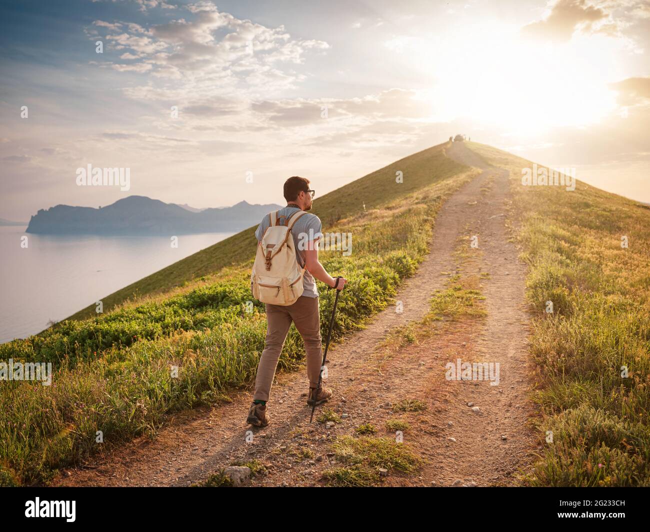 Der junge Mann reist alleine, geht auf Wanderwegen und genießt bei ...