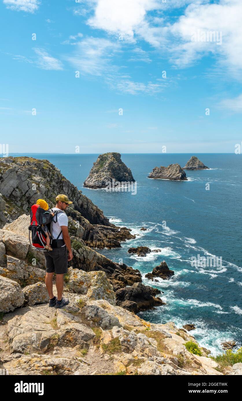 Junger männlicher Rucksacktourist, der auf dem Pen Hir Point auf der ...
