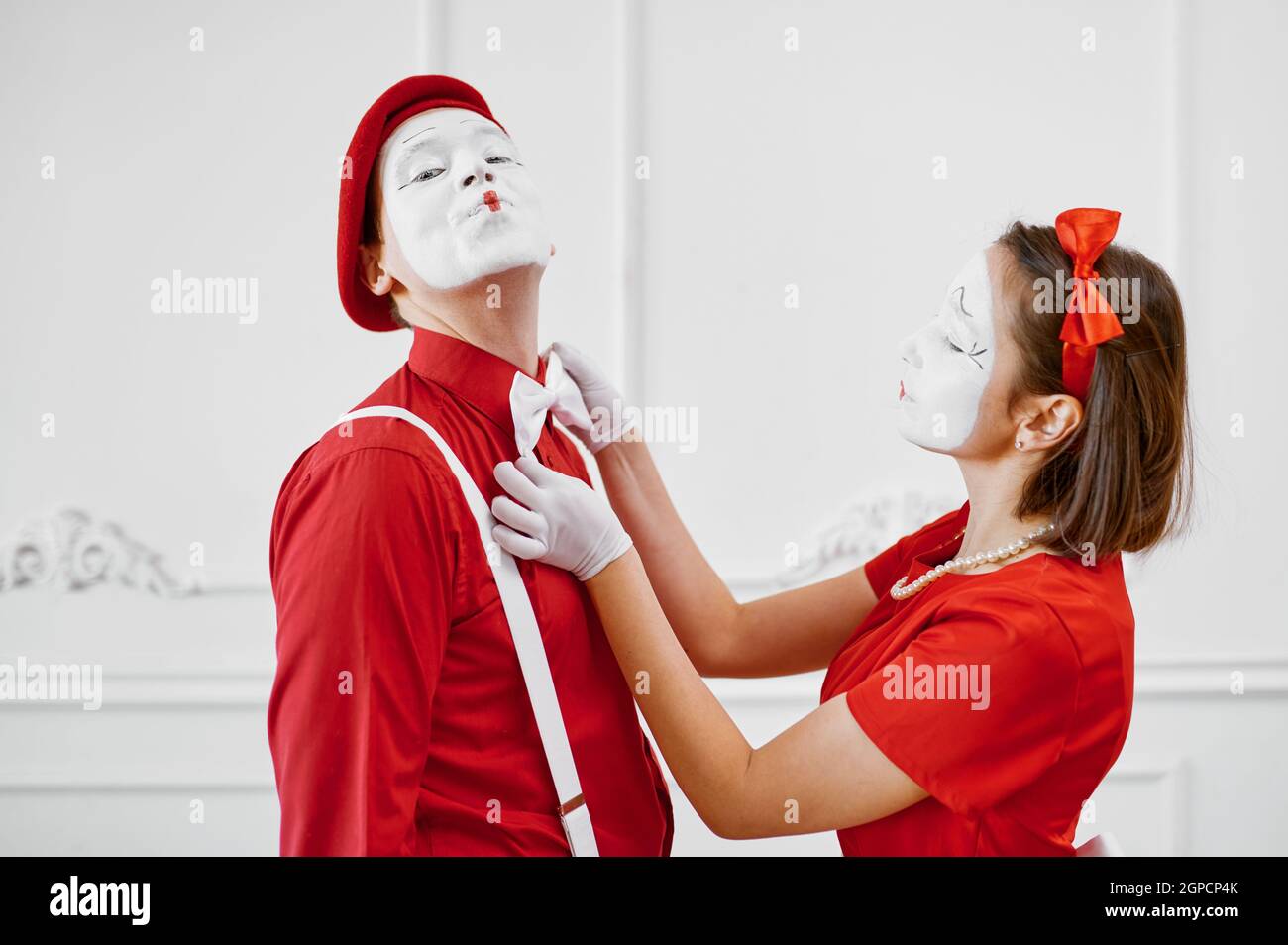 Zwei Mime-Künstler in roten Kostümen schauen sich an. Pantomime Theater ...