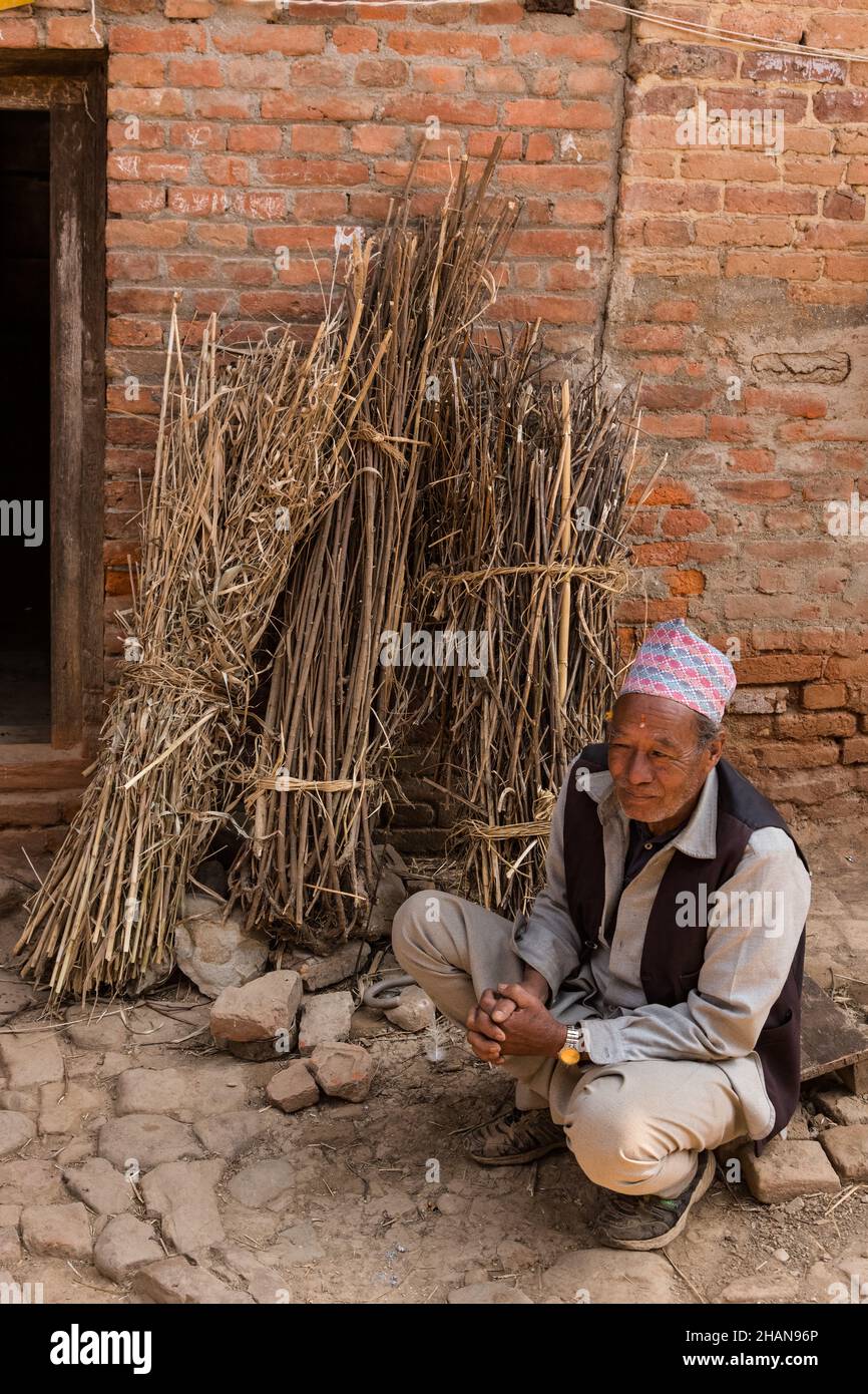 Ein nepalesischer Mann mit einem dhaka-Topi-Hut vor seinem Haus im ...