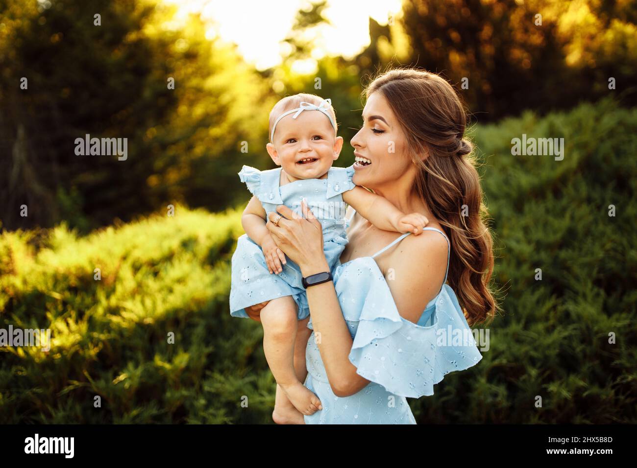 Schöne überglücklich Mutter spielen mit kleinen Tochter im Park ...