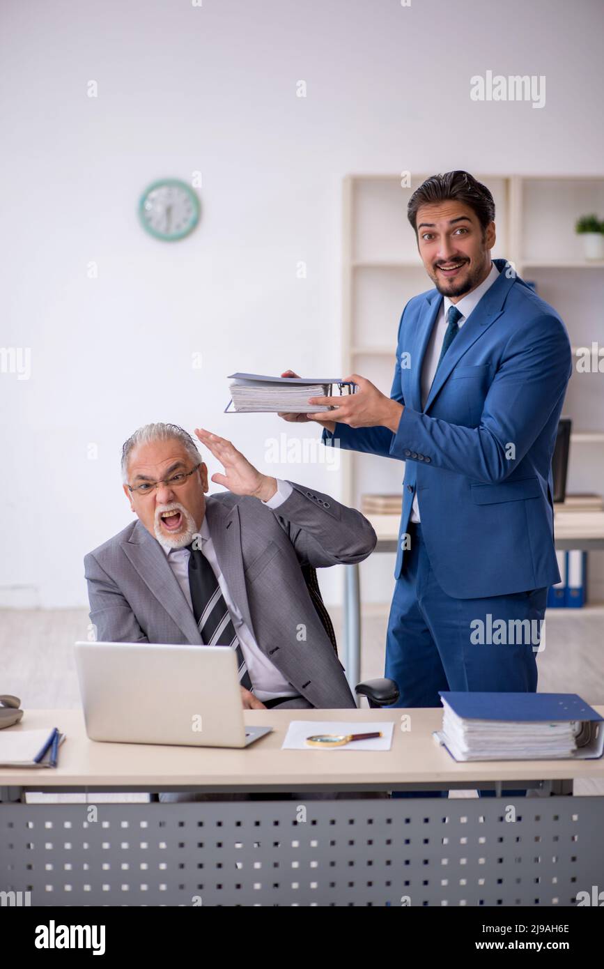 Alter Chef und junger Mitarbeiter am Arbeitsplatz Stockfotografie - Alamy