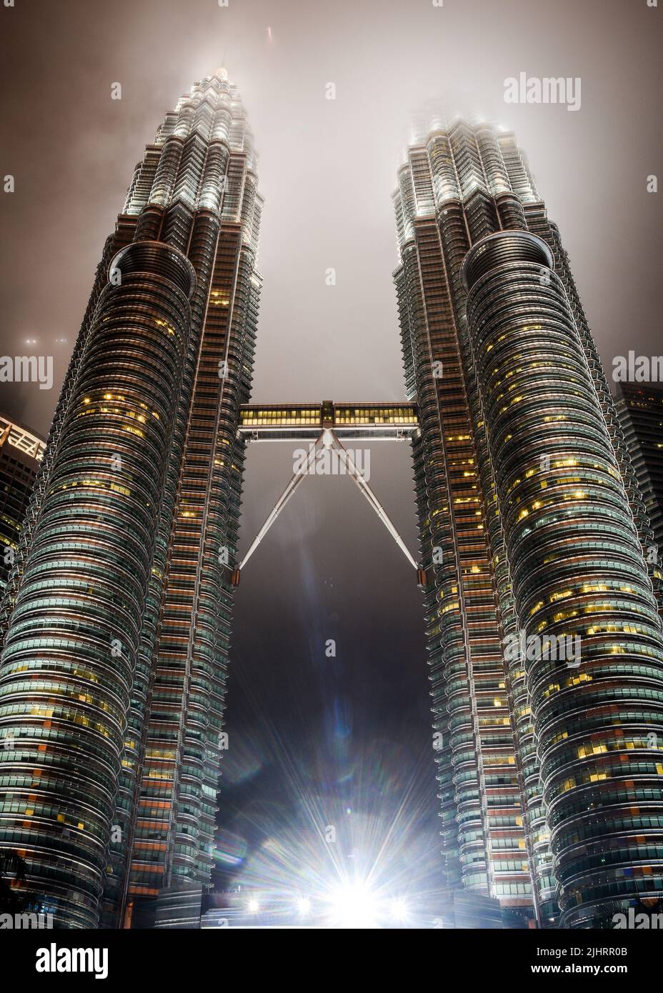 Eine vertikale Aufnahme der Petronas Twin Towers bei Nacht in Kuala Lumpur, Malaysia ...
