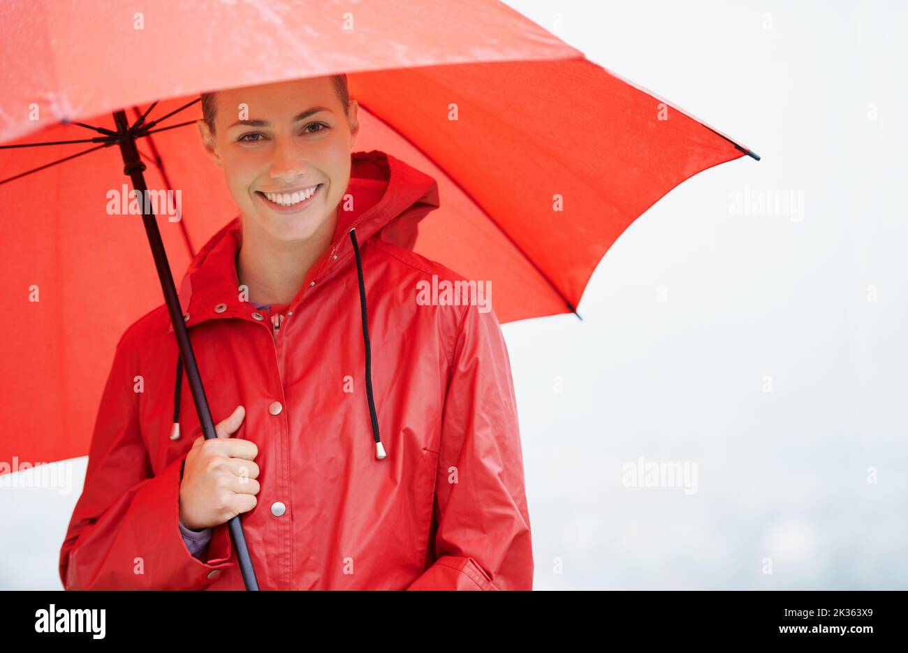 Young smiling woman wearing red umbrella -Fotos und -Bildmaterial in ...