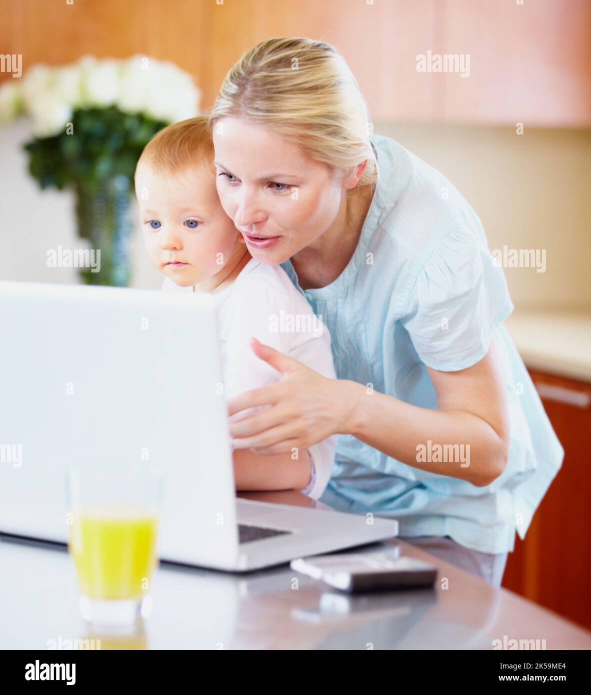 Ihm die Wege der Welt zeigen. Eine hübsche Mutter zeigt ihrem Baby, wie ...