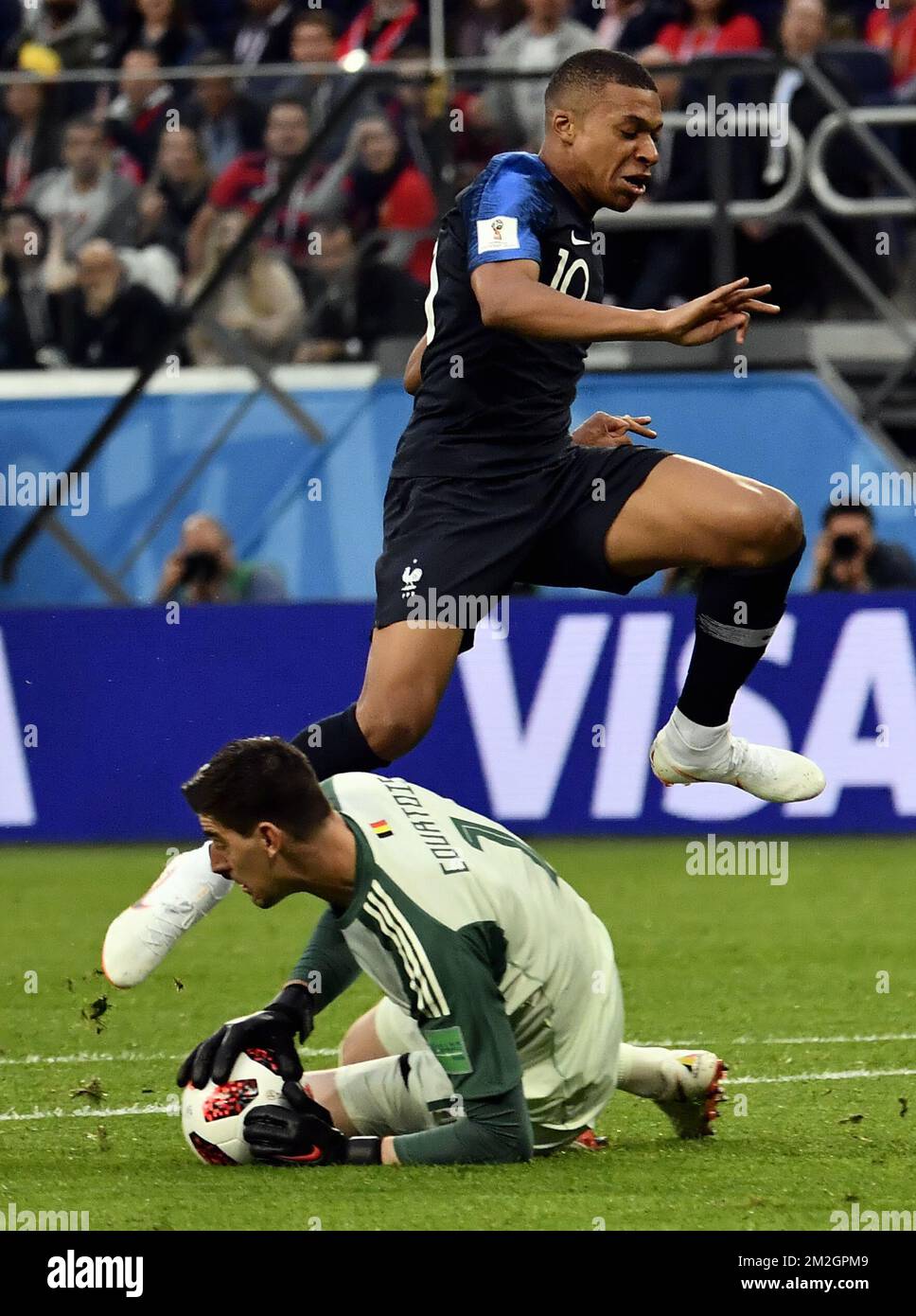 Belgium's goalkeeper Thibaut Courtois and France's Kylian Mbappe ...