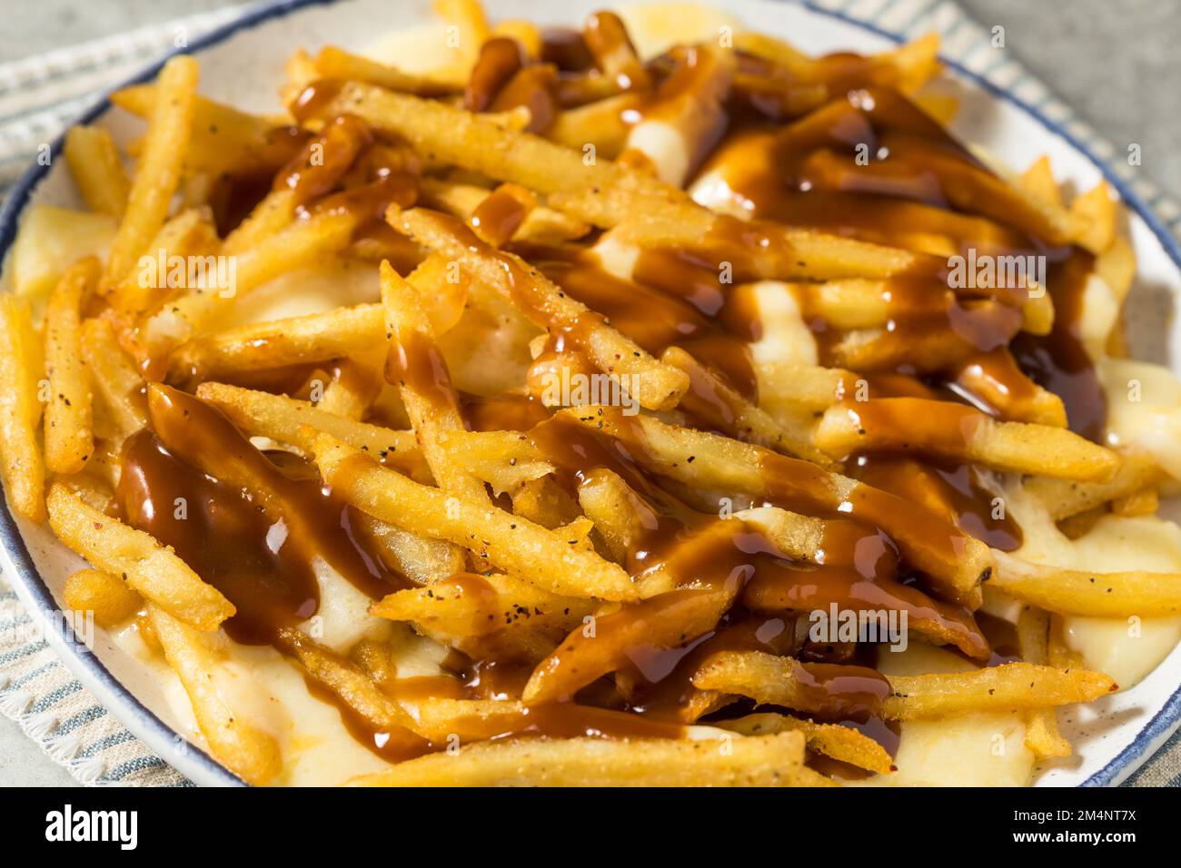 Hausgemachte kanadische Pommes frites mit Poutine-Soße und Käsequitten ...