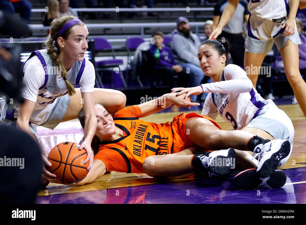 Oklahoma State guard Lexy Keys (15) falls to the court as she battles ...