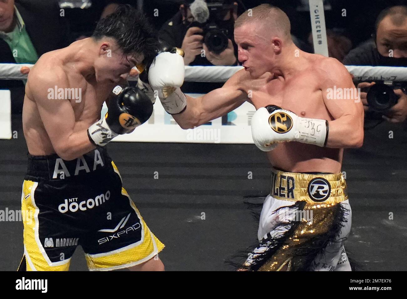 Paul Butler of Britain, right, throws a punch at Naoya Inoue of Japan ...
