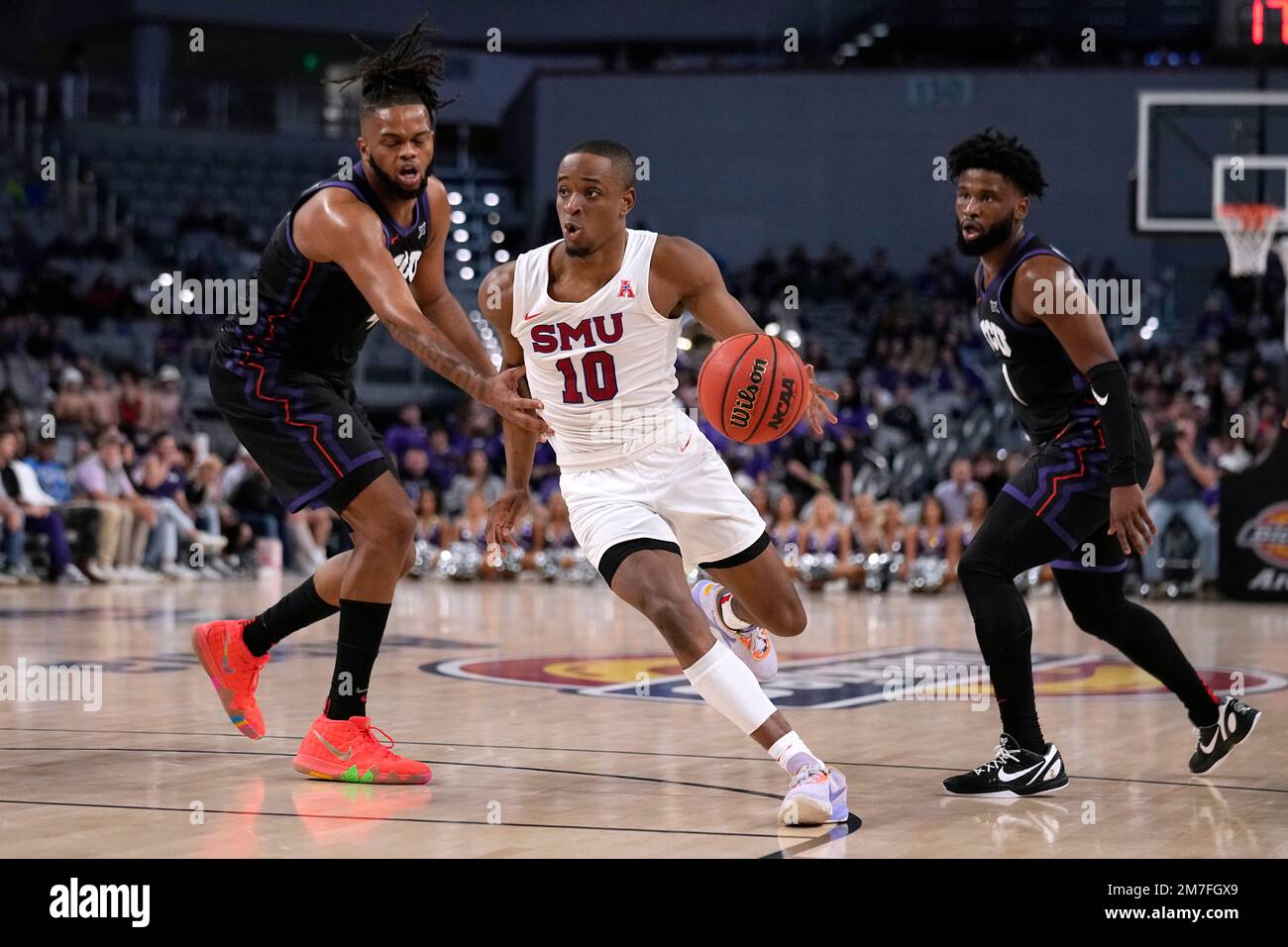 SMU guard Zach Nutall (10) drives to the basket between TCU's Eddie ...