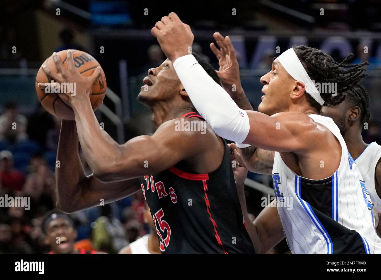 Toronto Raptors' Christian Koloko, left, looks to shoot in front of ...