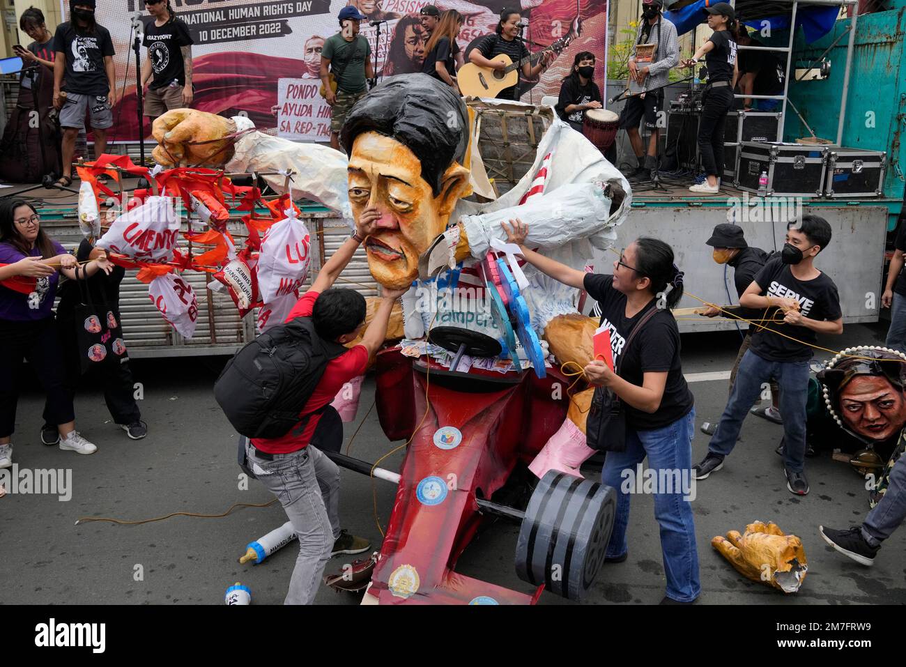 Protesters destroy an effigy of Philippine President Ferdinand Marcos ...