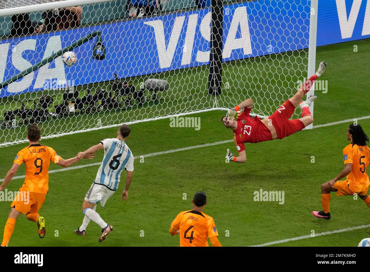 Argentina's goalkeeper Emiliano Martinez dives but fails to save the ...
