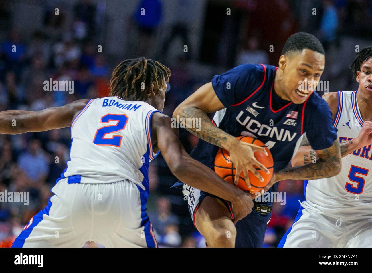 Connecticut guard Andre Jackson Jr. (44), center, gets pressure from ...