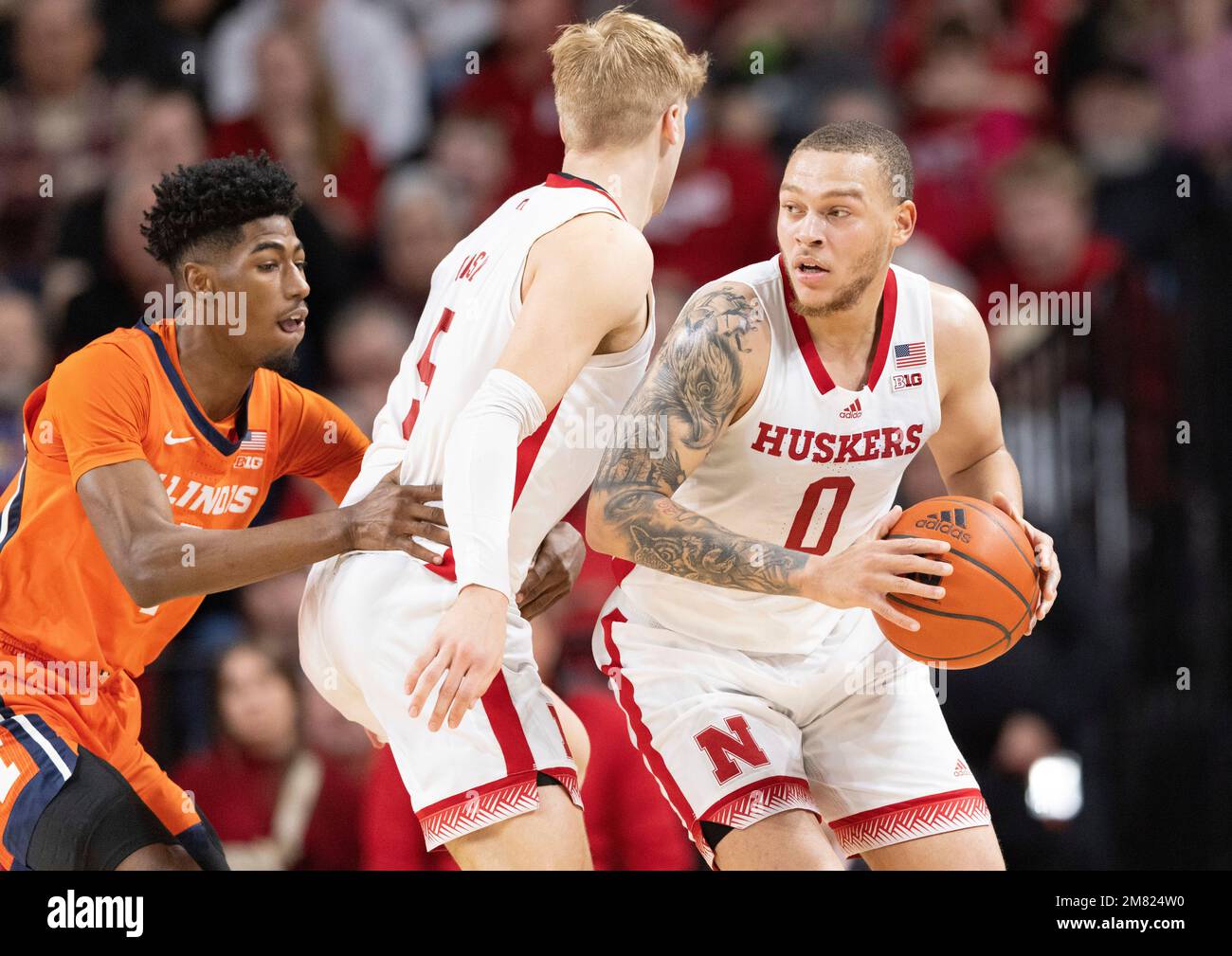 Nebraska's Sam Griesel, center, and C.J. Wilcher, right, play against ...