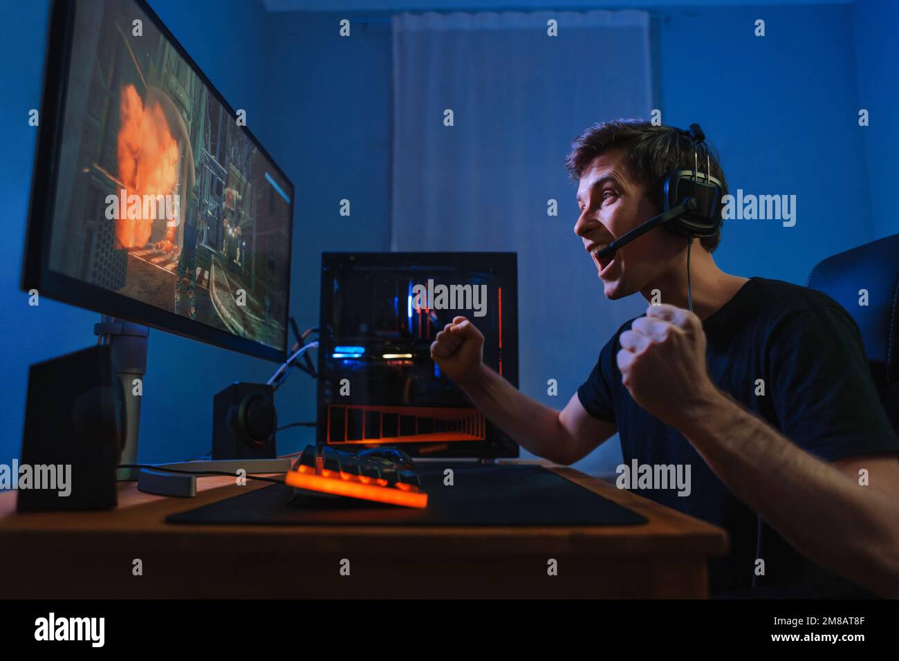 Cybersport junger Profi-Gamer, der mit dem Sieg des Spiels zufrieden ...