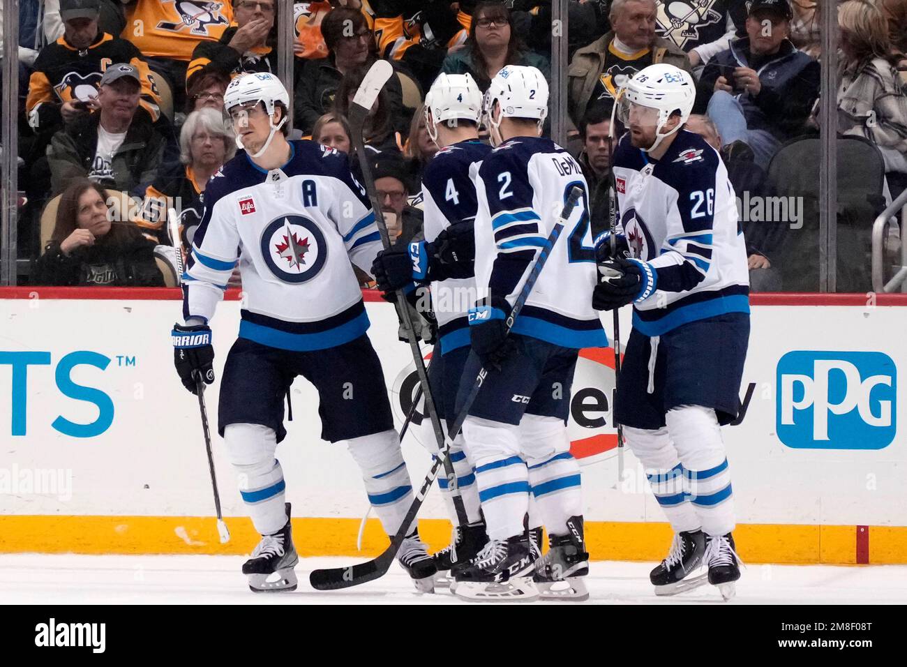 Winnipeg Jets' Mark Scheifele, left, returns to the bench after scoring ...