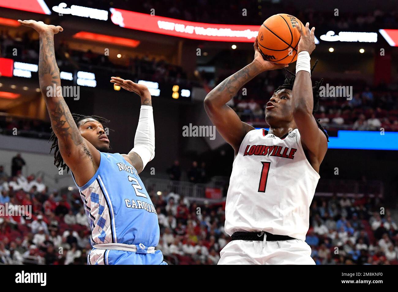 Louisville guard Mike James (1) attempts a shot over North Carolina guard Caleb Love (2) during ...