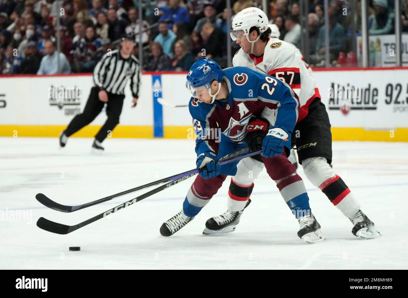 Colorado Avalanche center Nathan MacKinnon (29) jostles for the puck ...