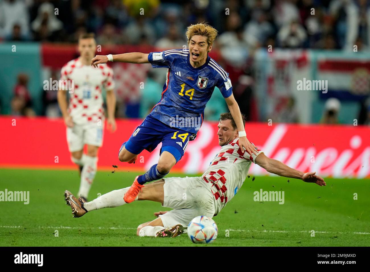 Japan's Junya Ito, left, and Croatia's Borna Barisic fight for the ball ...