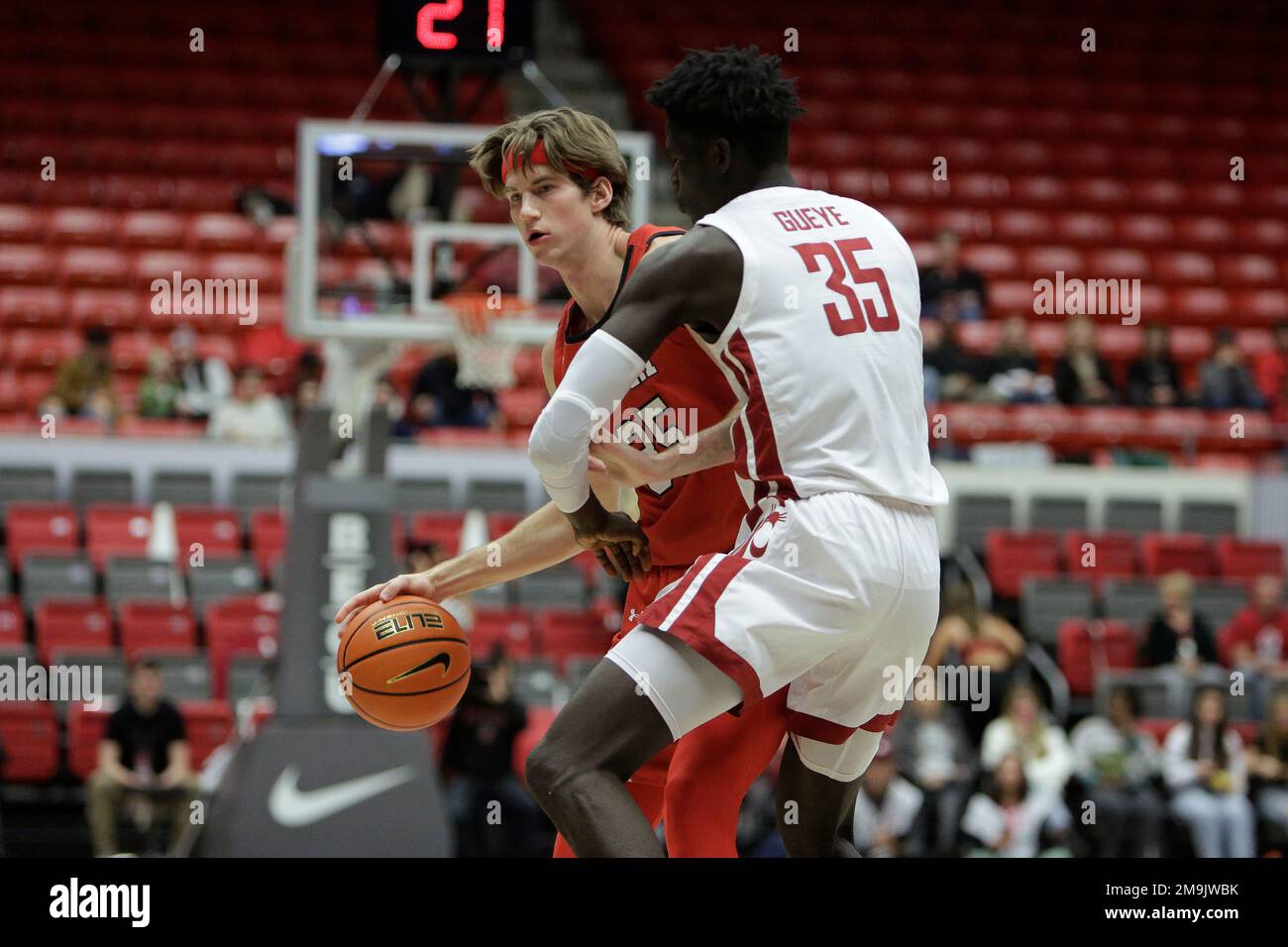 Utah center Branden Carlson, left, controls the ball while defended by ...