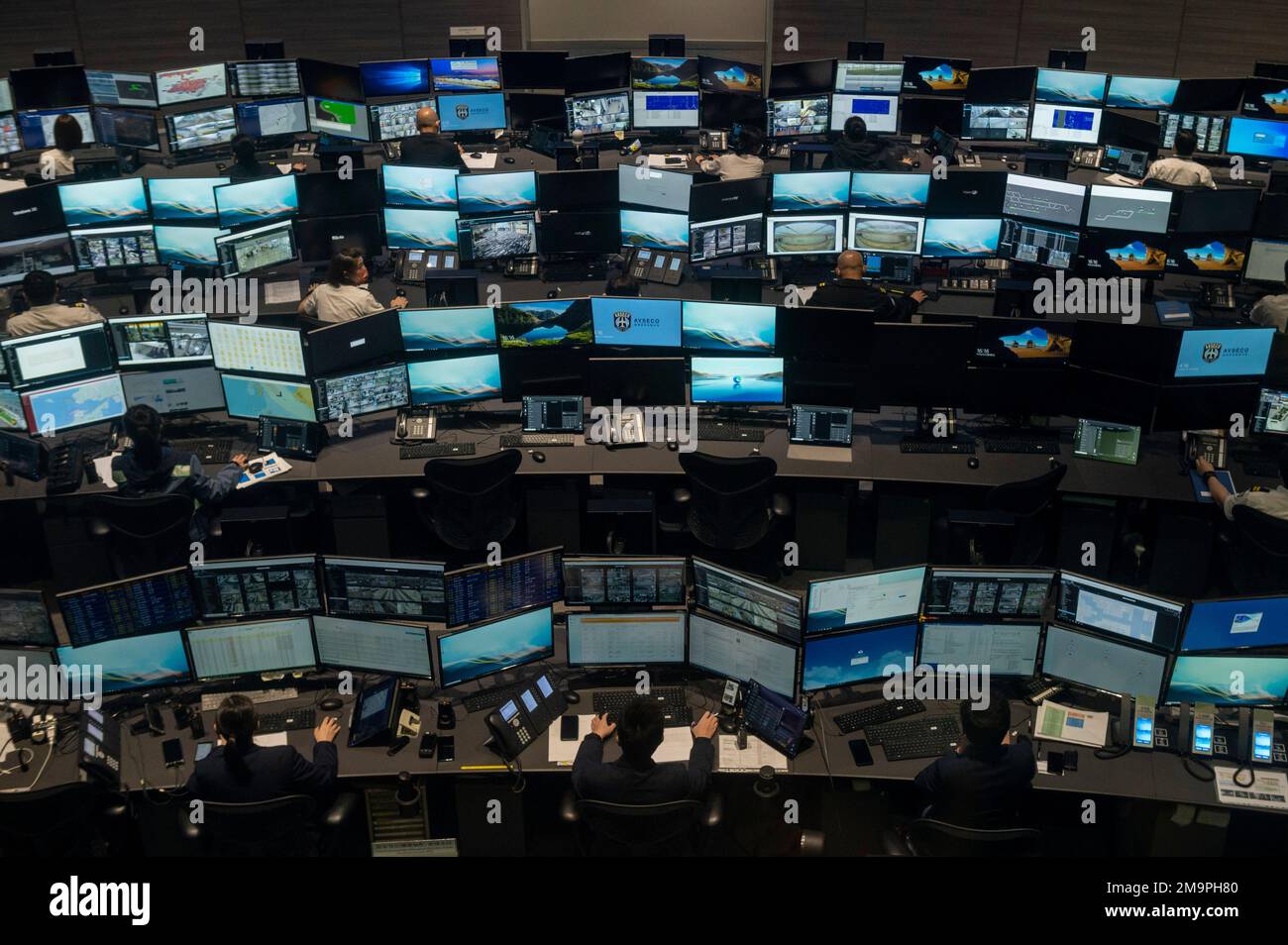 Workers monitor displays at the Integrated Airport Center at Hong Kong ...
