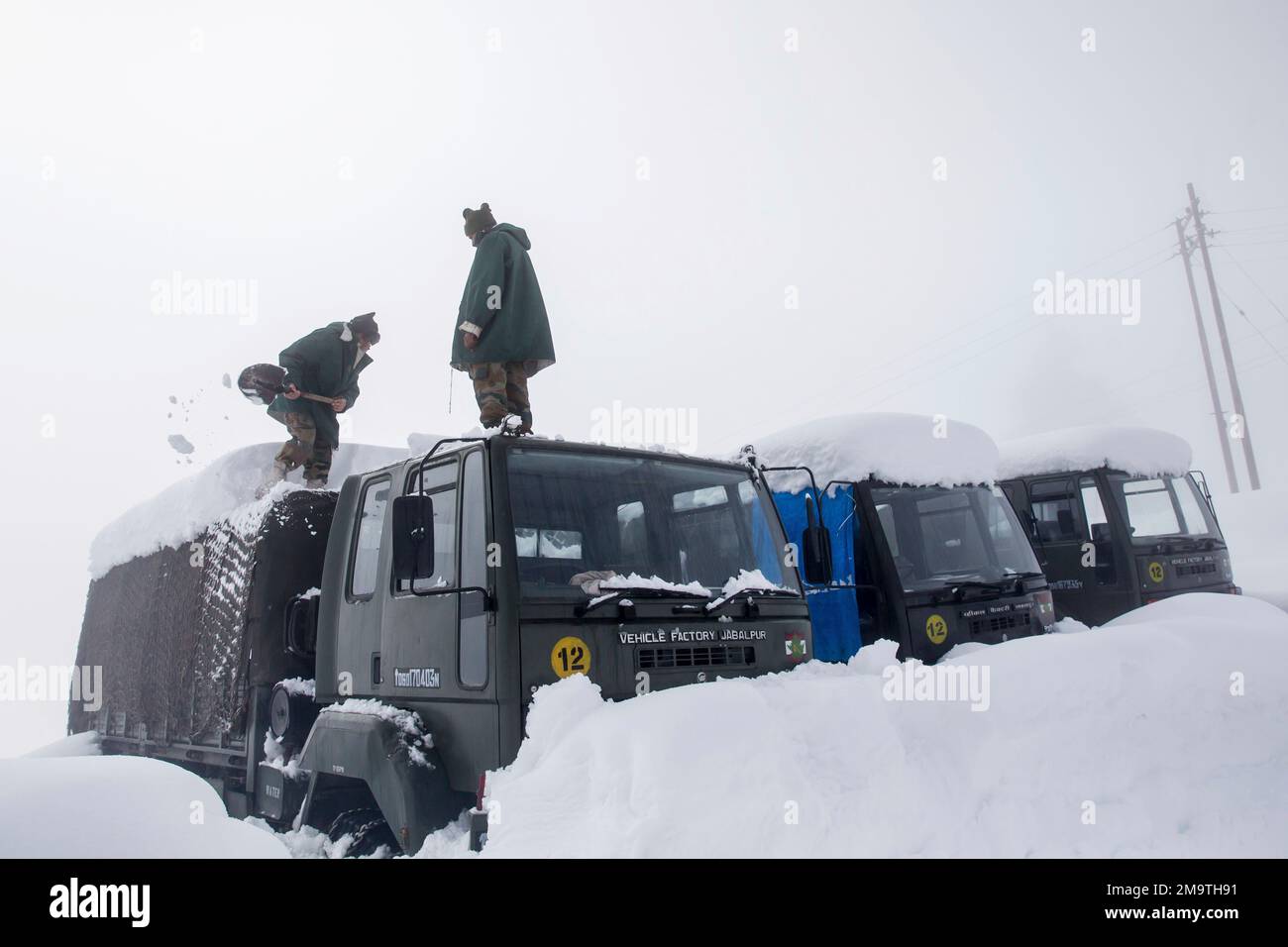FILE - Indian Army soldiers clear snow from their stranded vehicles ...