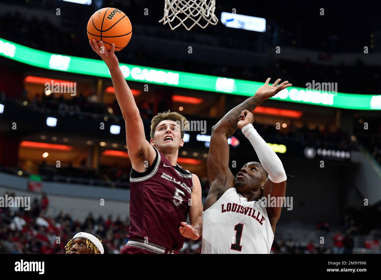 Bellarmine guard Peter Suder (5) shoots over Louisville guard Mike ...