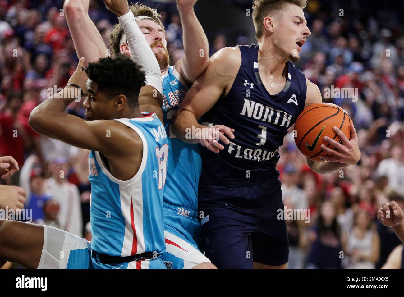 North Florida forward Carter Hendricksen, right, secures a rebound next ...