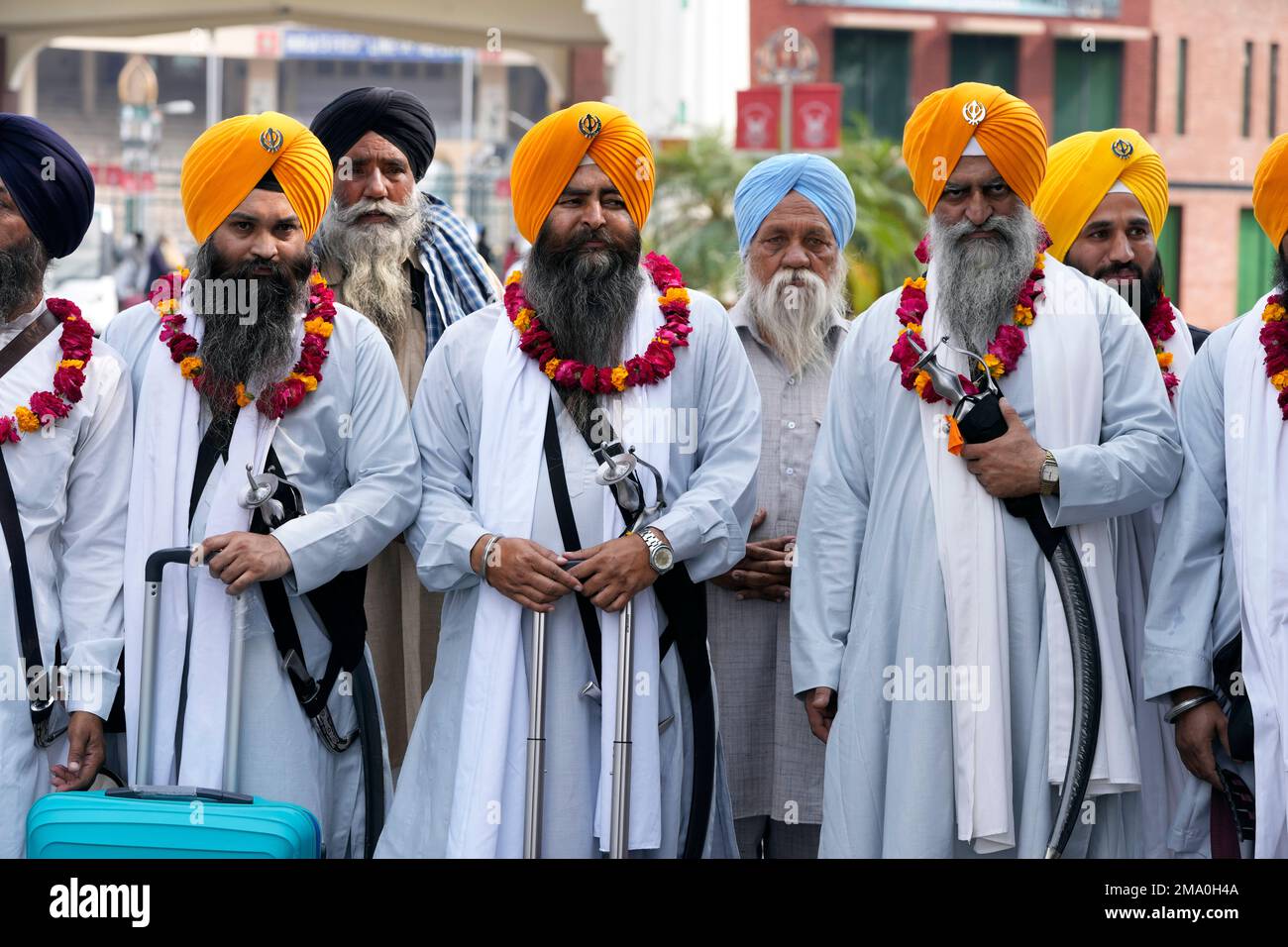 Indian Sikh pilgrims enter Pakistan through the Wagah border crossing ...