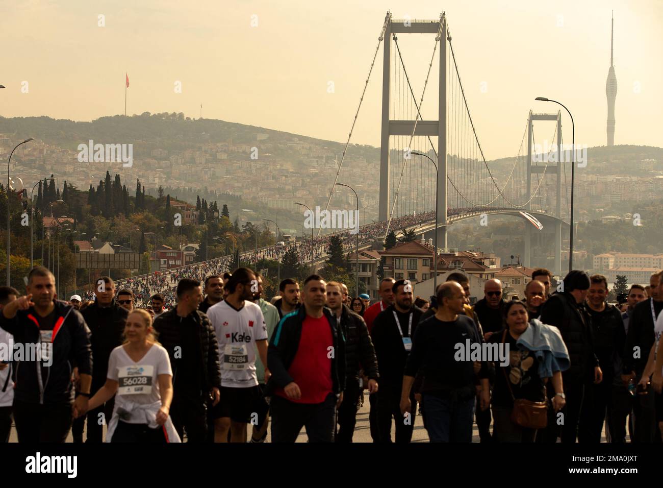 Runners cross the 15th July Martyrs bridge over the Bosphorus during ...