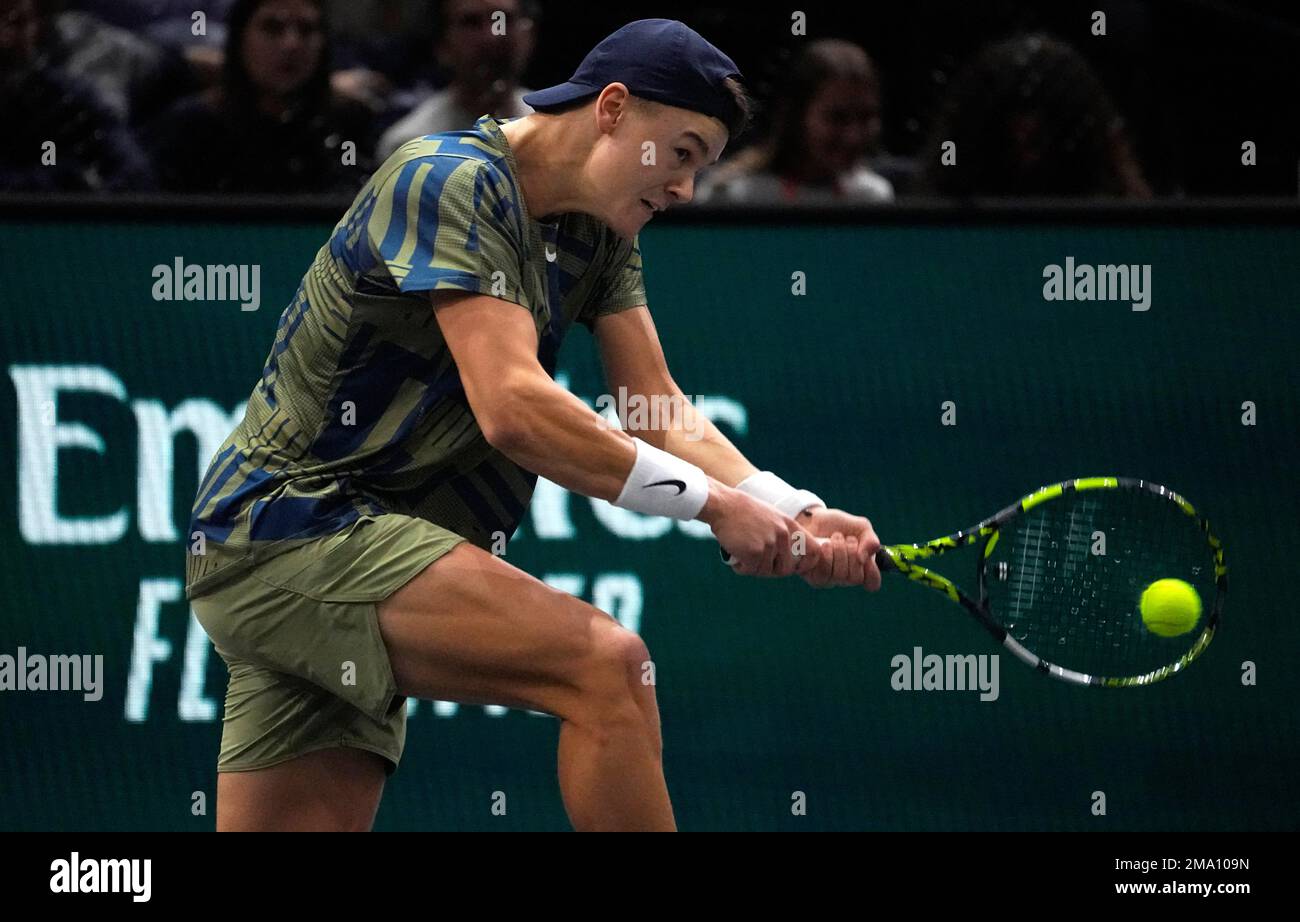 Holger Rune from Denmark returns the ball to Felix Auger-Aliassime of Canada during their semi ...