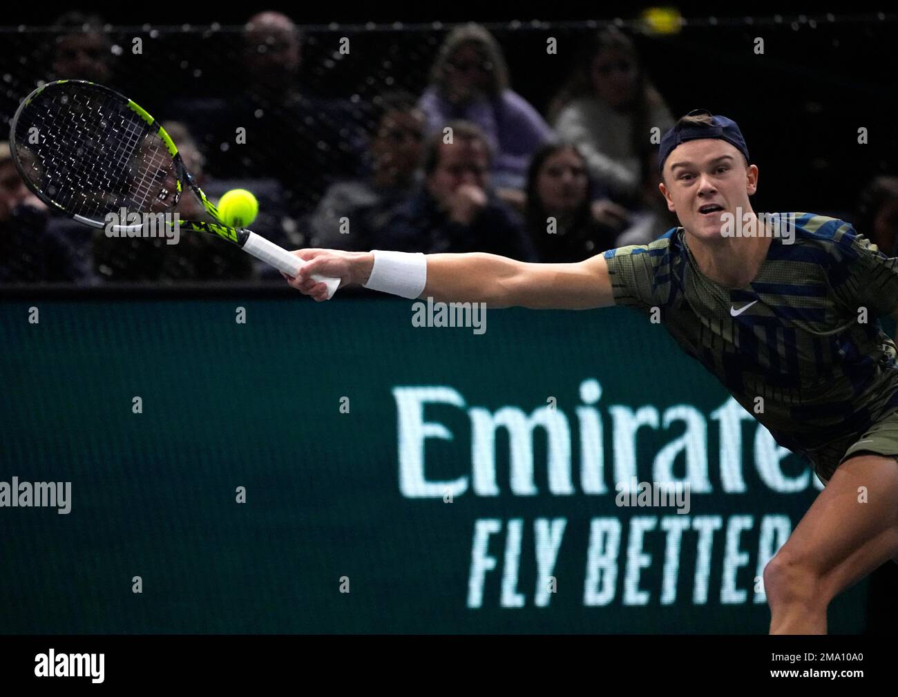 Holger Rune from Denmark returns the ball to Felix Auger-Aliassime of Canada during their semi ...
