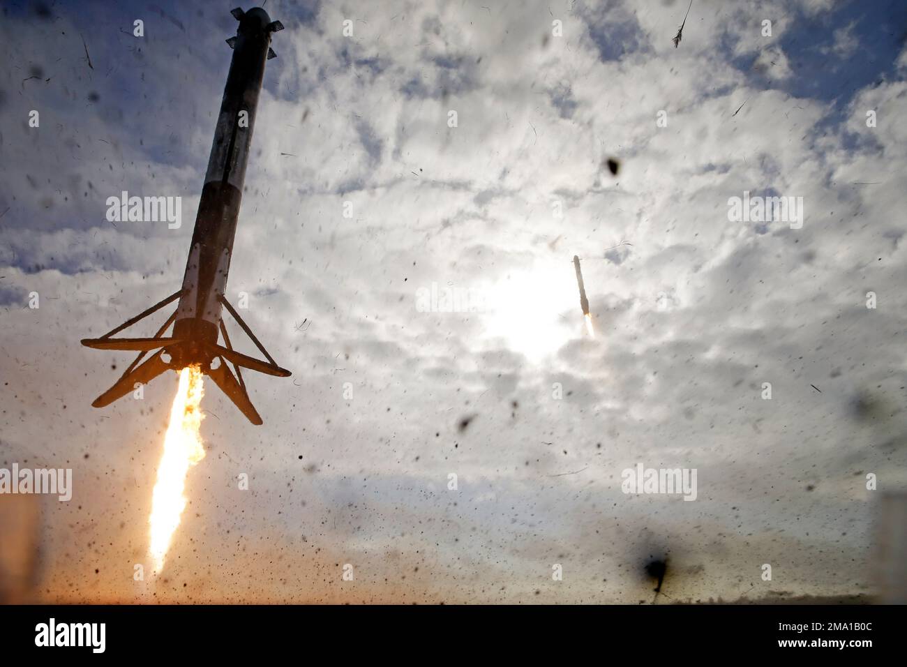 A SpaceX Falcon Heavy rocket's two side boosters, left and, center rear ...