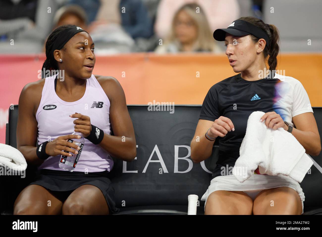 Coco Gauff, left, and Jessica Pegula, right, talk during a break in ...