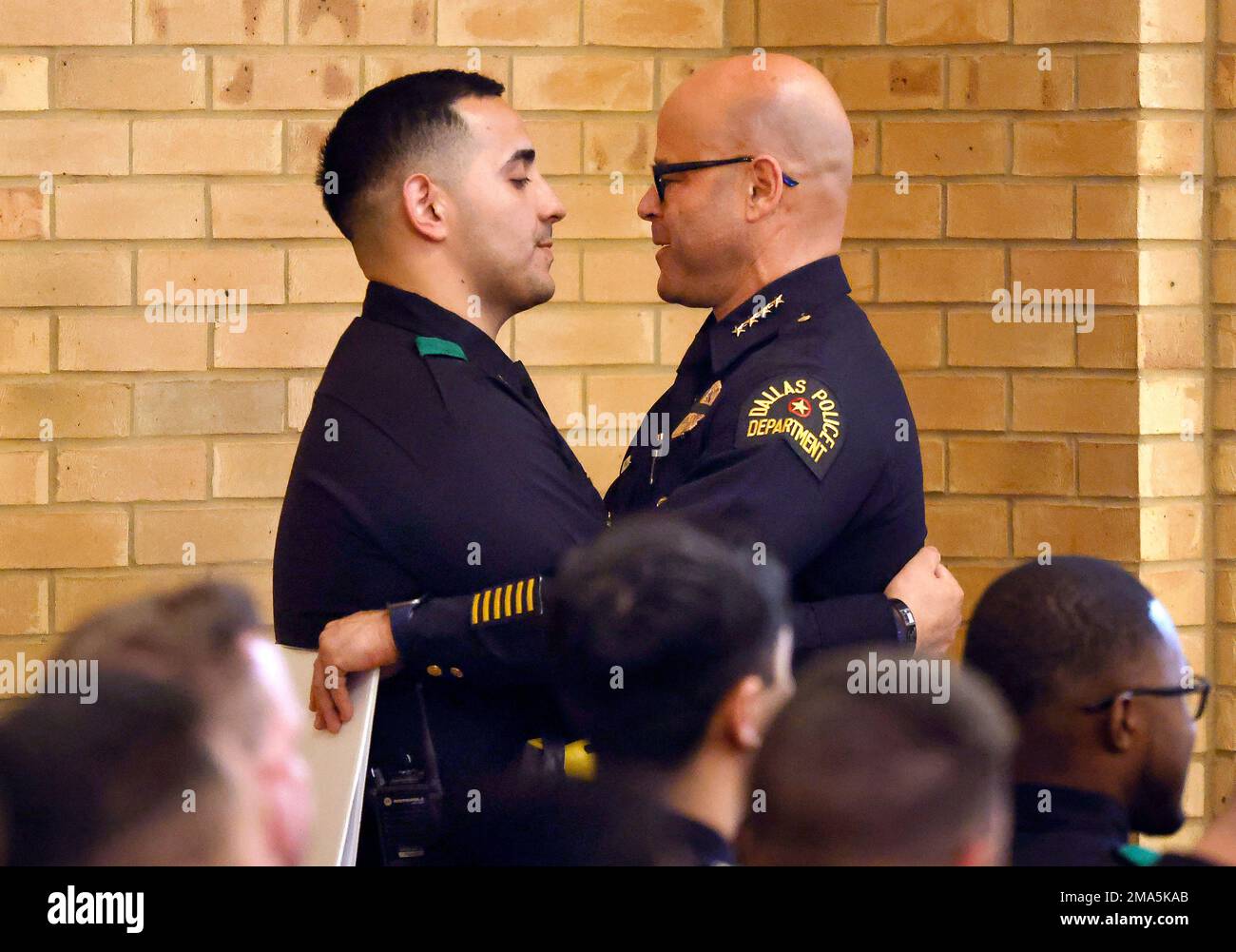 Dallas Police Chief Eddie Garcia, right, gives Dallas Police Officer ...