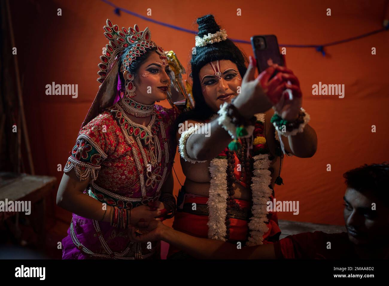Artists dressed as Hindu god Ram and his wife Sita take a selfie before ...