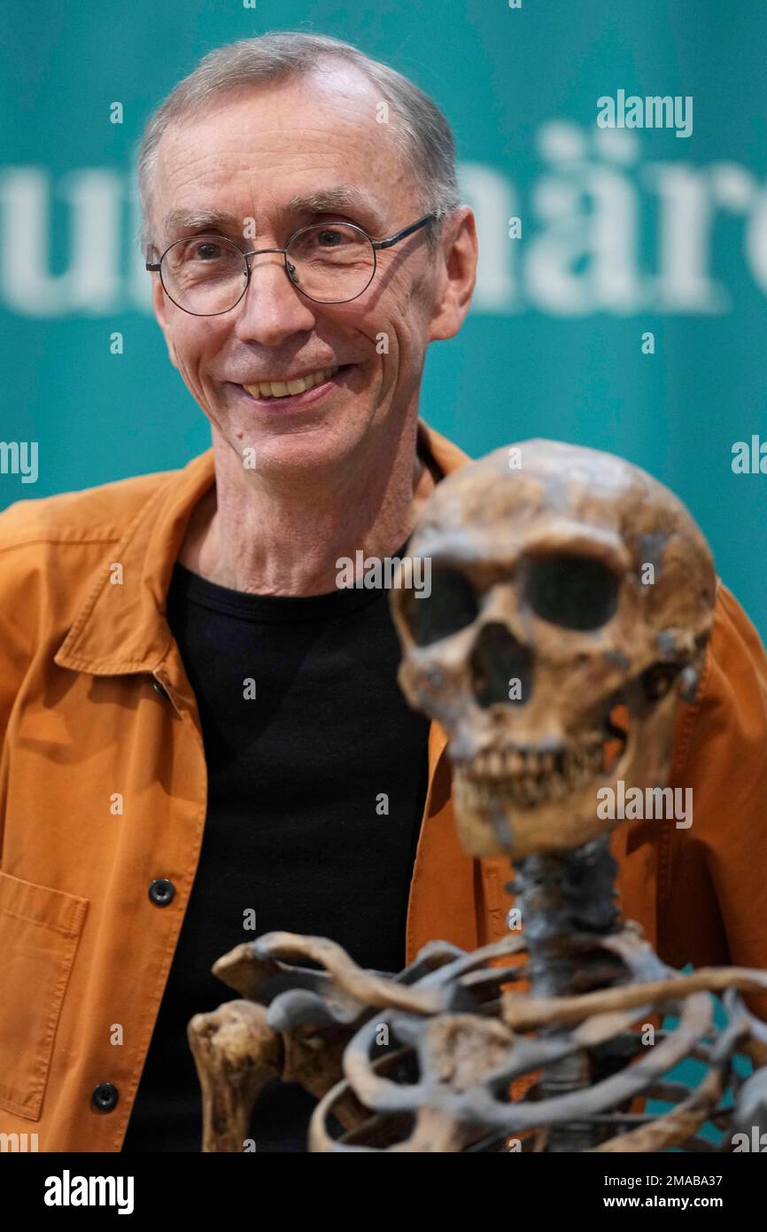 Swedish scientist Svante Paabo poses behind a replica of a Neanderthal ...