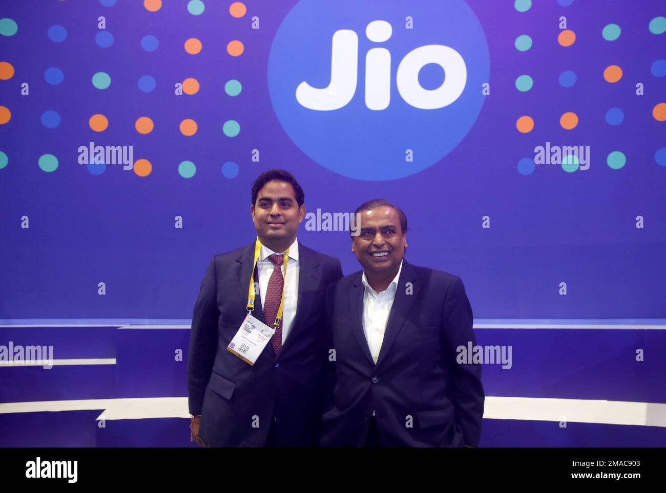 Chairman of Reliance Industries Limited Mukesh Ambani stands with his ...
