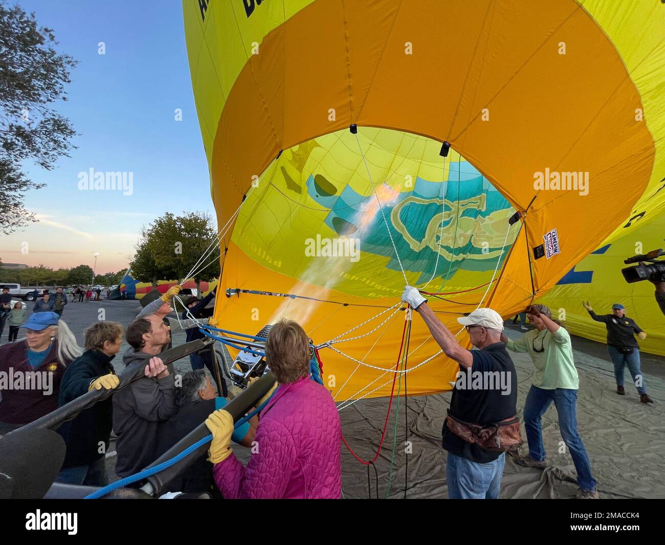 Crew members inflate a hot air balloon as part of a re-enactment of the ...