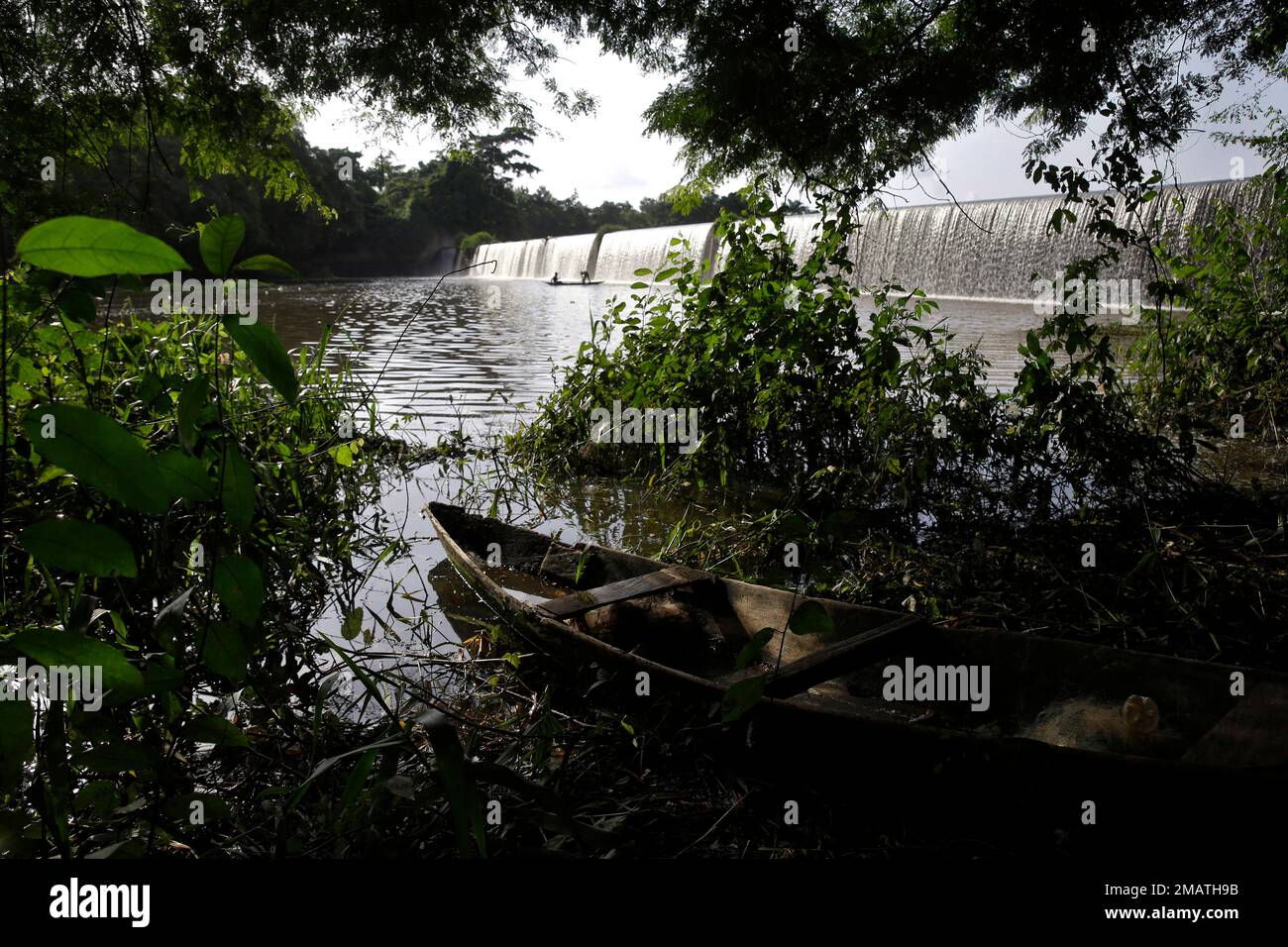 A fishing canoe sits near a dam that sources the sacred Osun River in ...