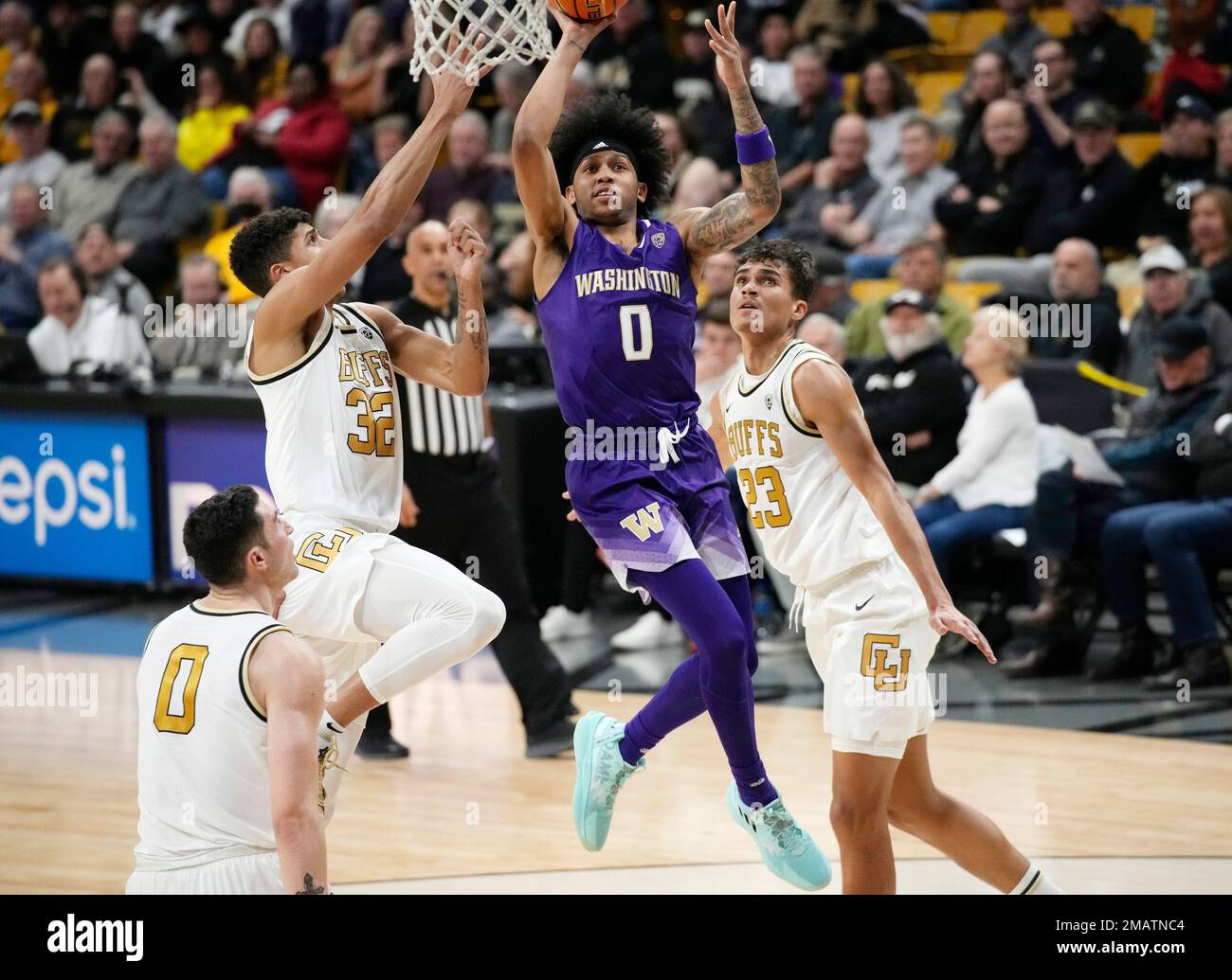 Washington guard Koren Johnson, center, drives to the rim between ...