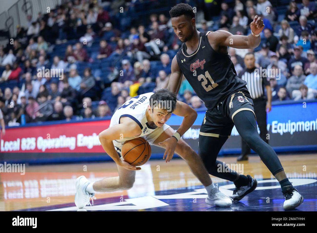 Monmouth guard Jack Collins (13) drives against Charleston guard Jaylon ...
