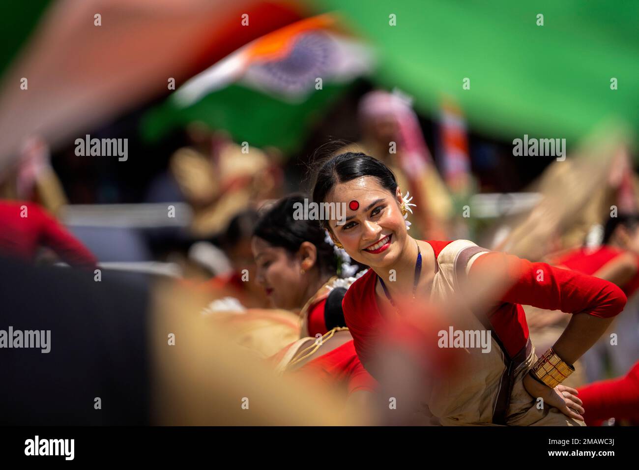 Assamese girls and boys in traditional attire carry Indian flags as ...
