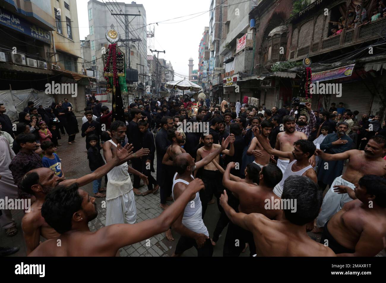 Shiite Muslims beat their chests in a ritual during a Muharram ...