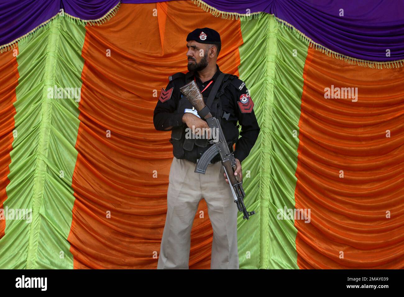 A police officer stands guard at a cordon-off street to ensure security ...