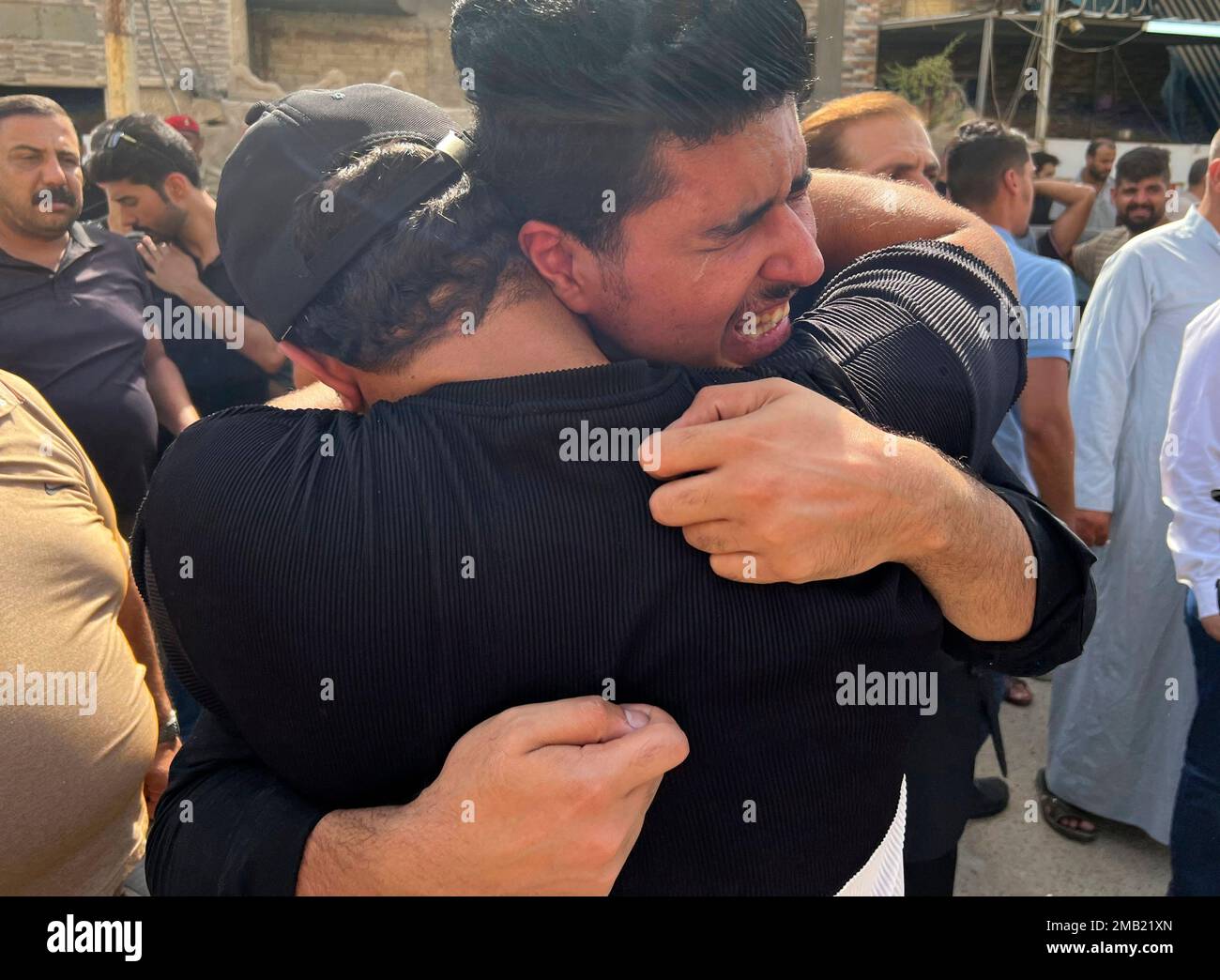 Men mourn Abbas Abdul Hussein, a 30-year-old victim of an artillery ...