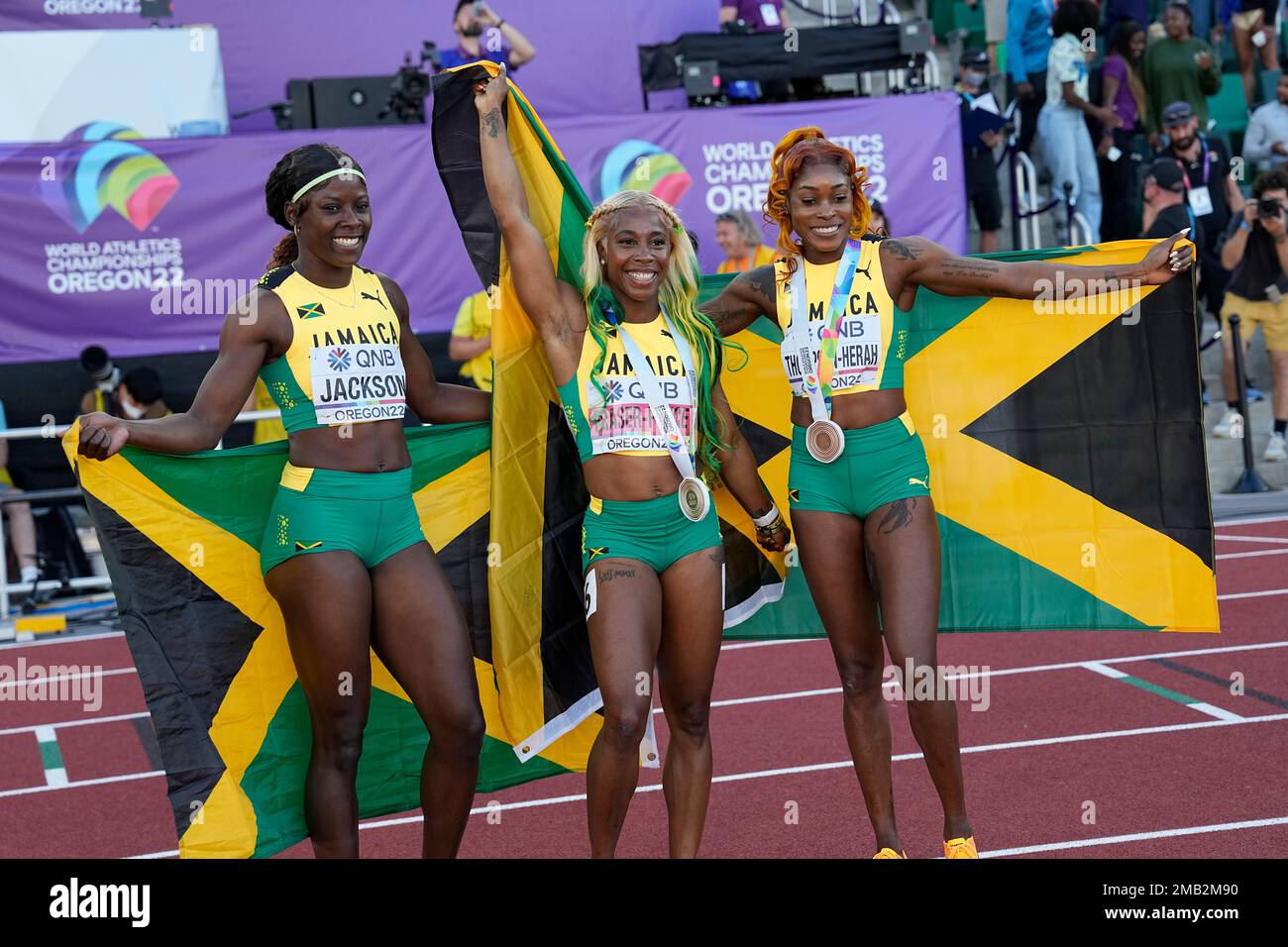 Gold medalist Shelly-Ann Fraser-Pryce, of Jamaica, center, stands with silver medalist Shericka ...