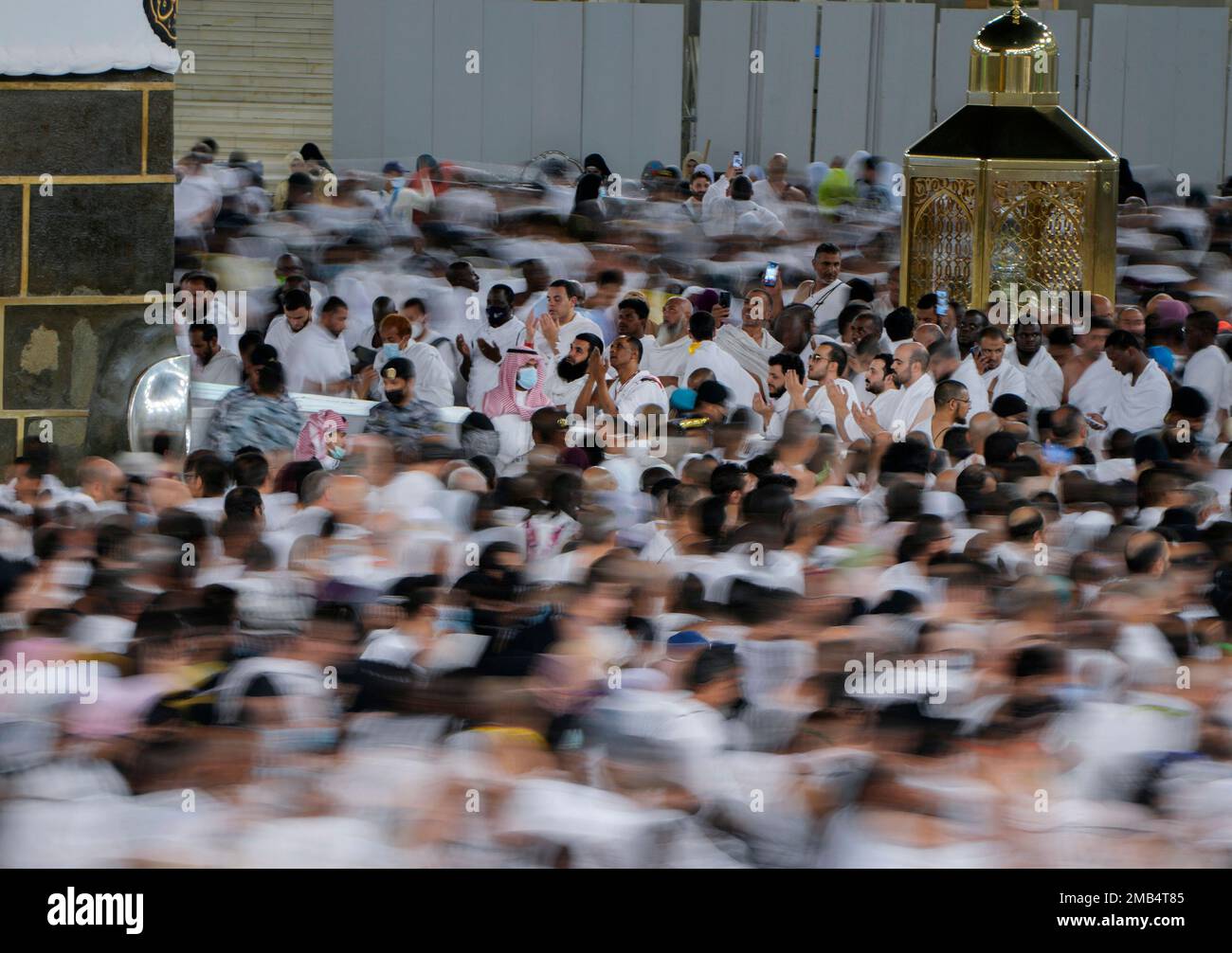 In this photo taken with low shutter speed, Muslim pilgrims pray as ...