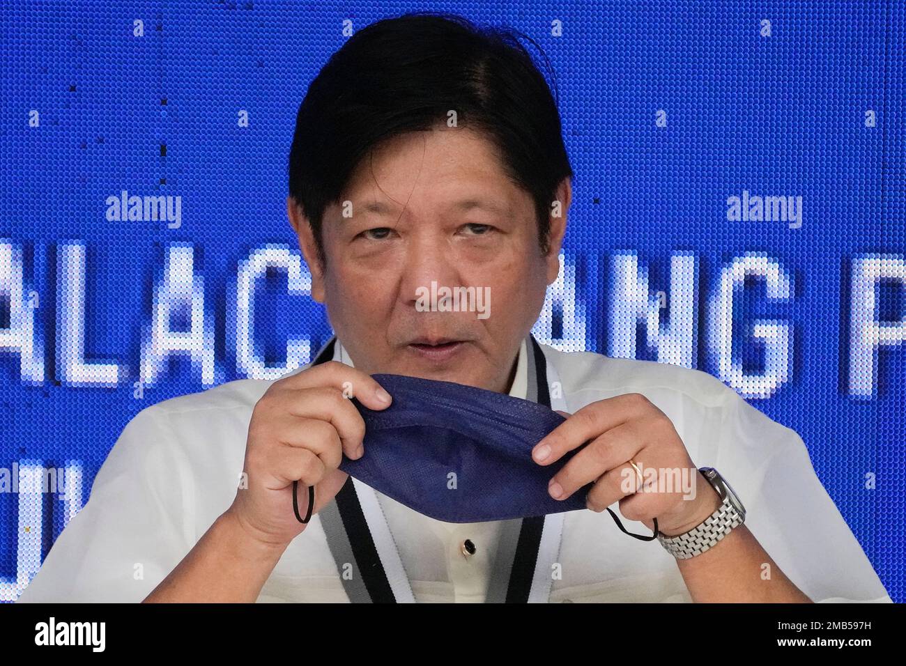 Philippine President Ferdinand Marcos Jr., wears back his face mask ...